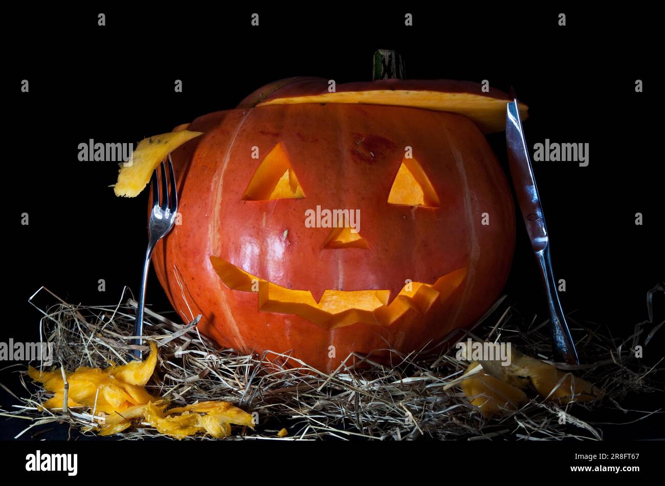 Halloween pumpkin inside lit by candle, spooky looking, black ...