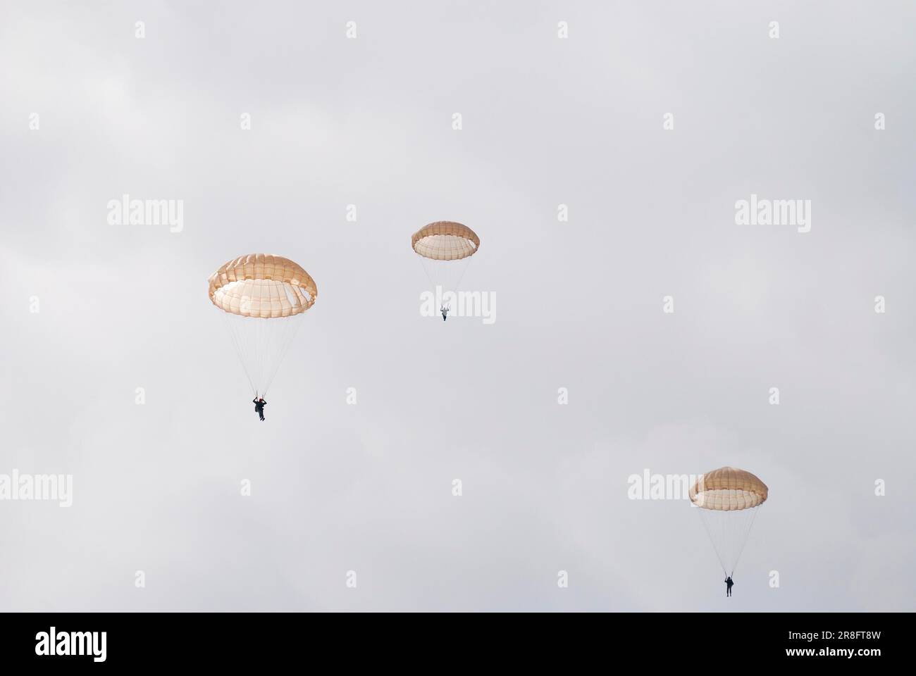 Three parachuters on the sky Stock Photo - Alamy