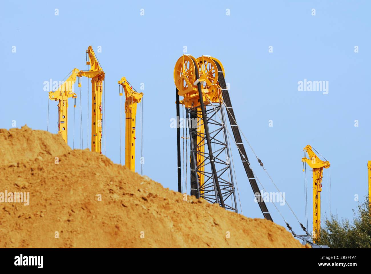 Construction site with drilling rigs behind a sand hill Stock Photo - Alamy