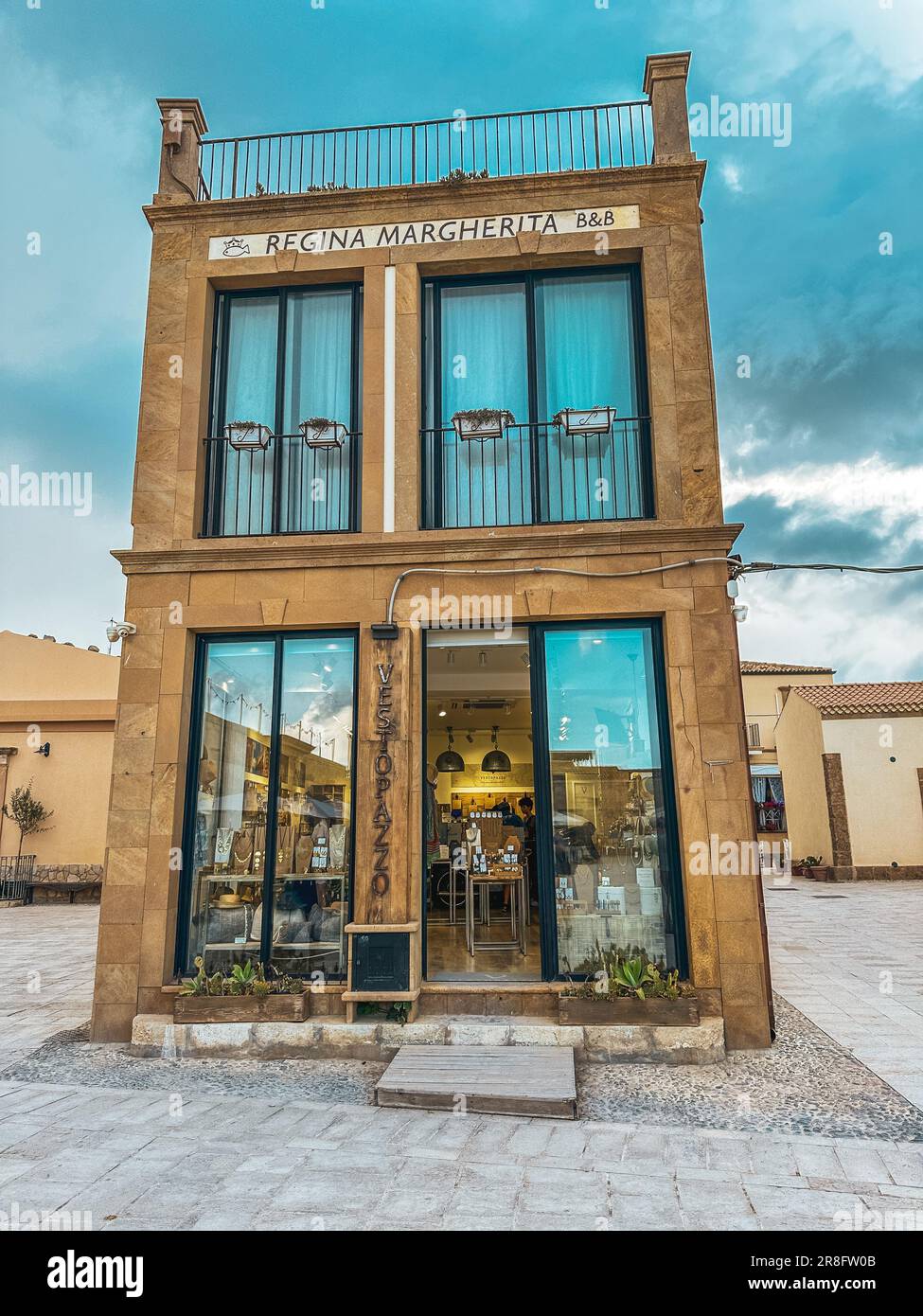 A single standing double story building with small shop and reflecting ...