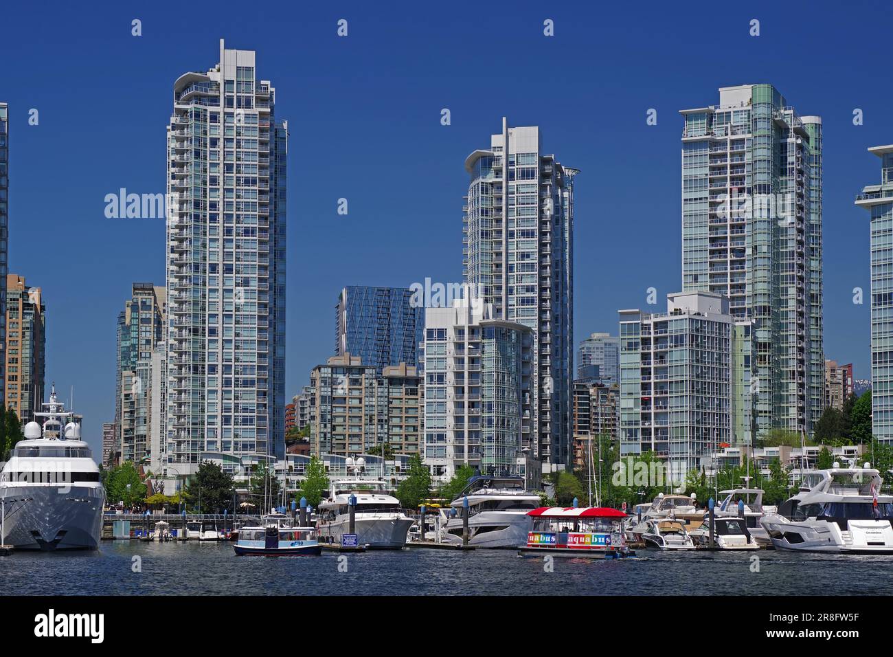 Small boats and yachts in front of skyscraper canyons, False Creek, Granvillle Bridge, Vancouver ...