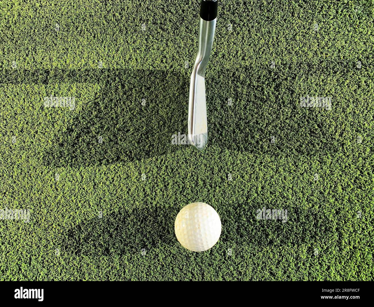 Golf Club and Ball with Double Shadow on Mat on Driving Range in ...