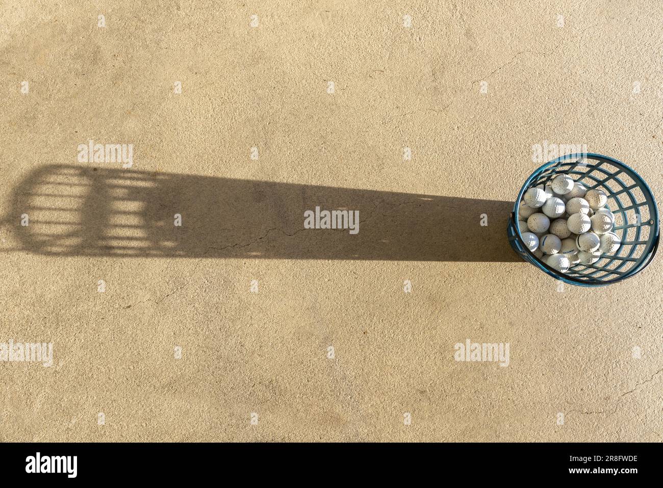 Driving Range Basket with Golf Balls and Shadow Stock Photo - Alamy