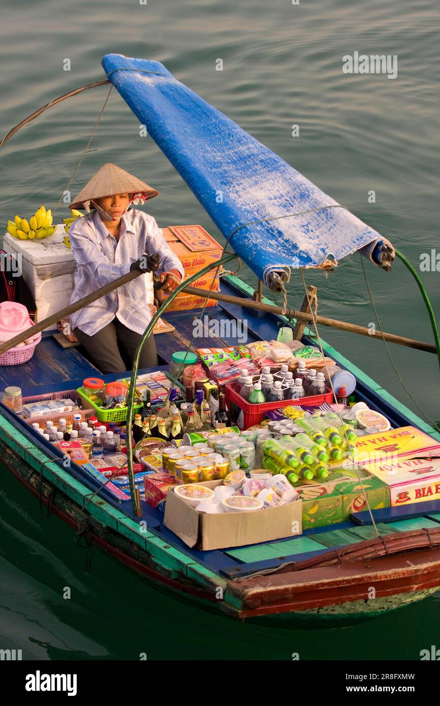 Floating market, trader in boat with food, Halong Bay, Gulf of Tonkin ...