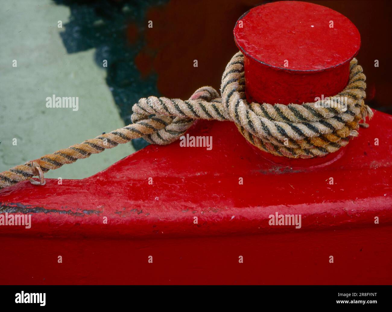 Bollard with rope, fishing boat Stock Photo - Alamy