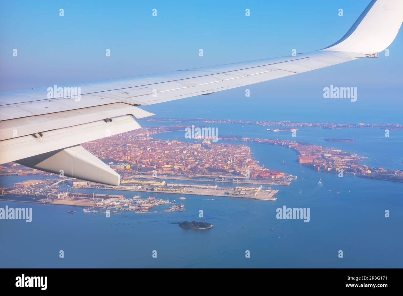 View from the window of an airplane flying above Venice old town ...