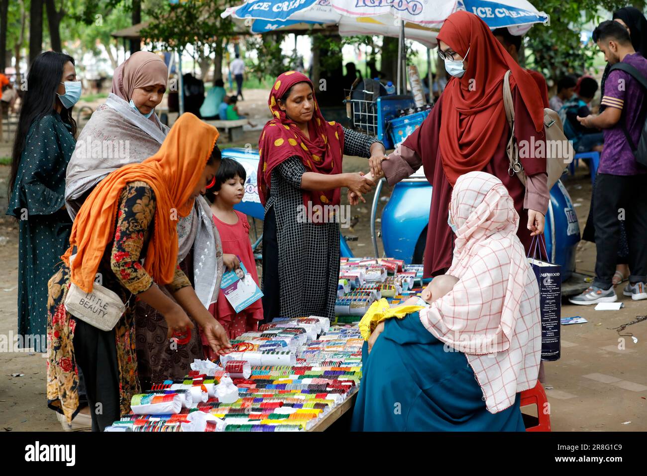Dhaka, Bangladesh - June 20, 2023: A vendor is selling traditional Bengali glass bangles on the ...