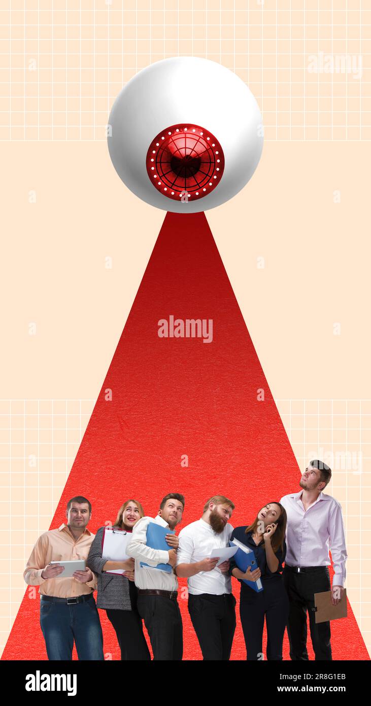 Employees standing under giant eye of boss attentively checking work ...