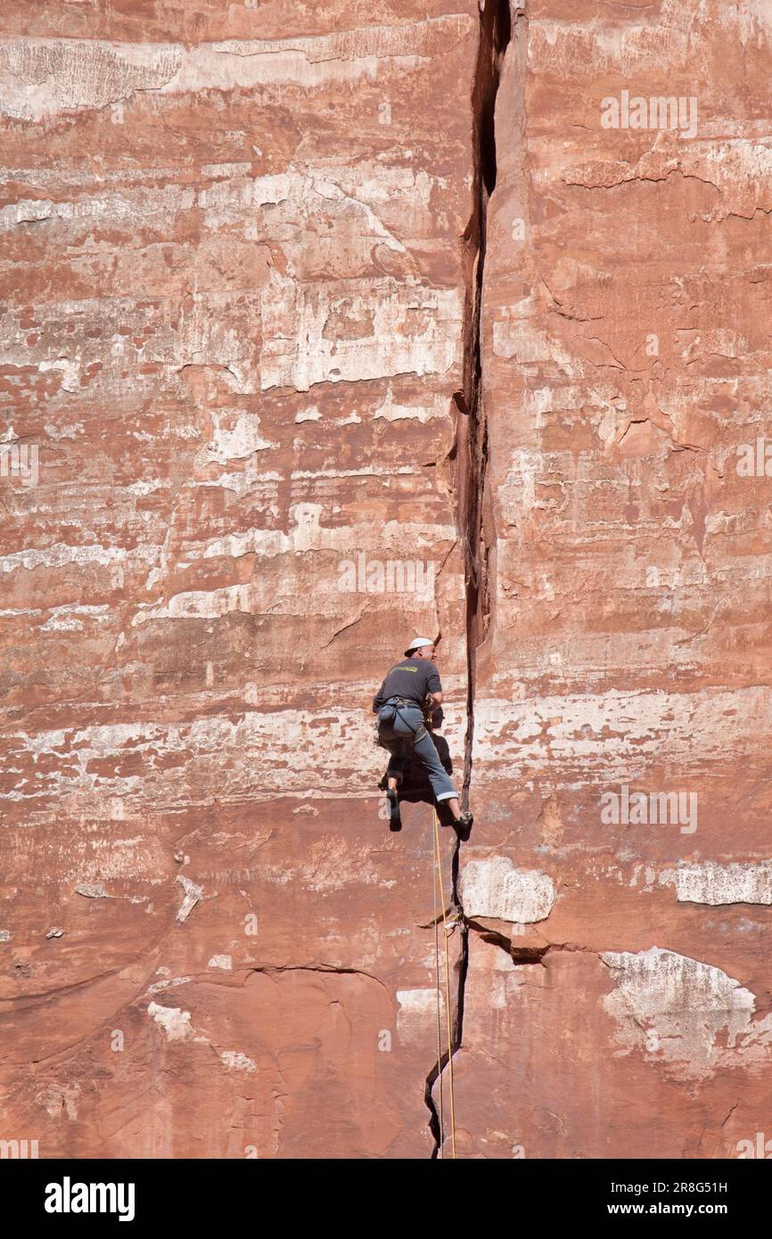 Man climbing sheer rock face in Zion National Park Stock Photo - Alamy