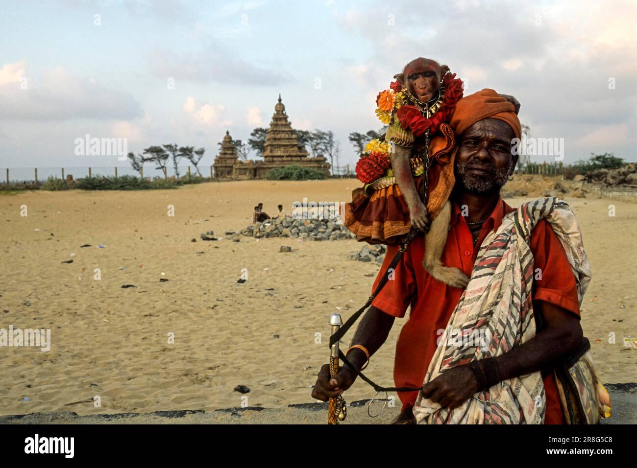 Monkey charmer behind shore temple in Mahabalipuram Mamallapuram near ...