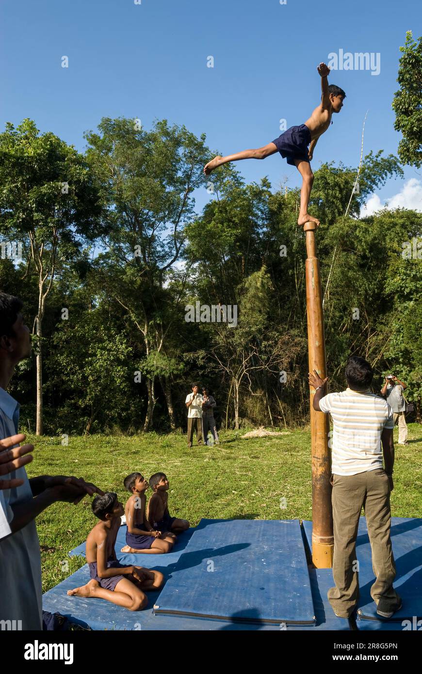 A boy performing Indian Pole Gymnastics, Mallakhamba mallakhamb is an ...