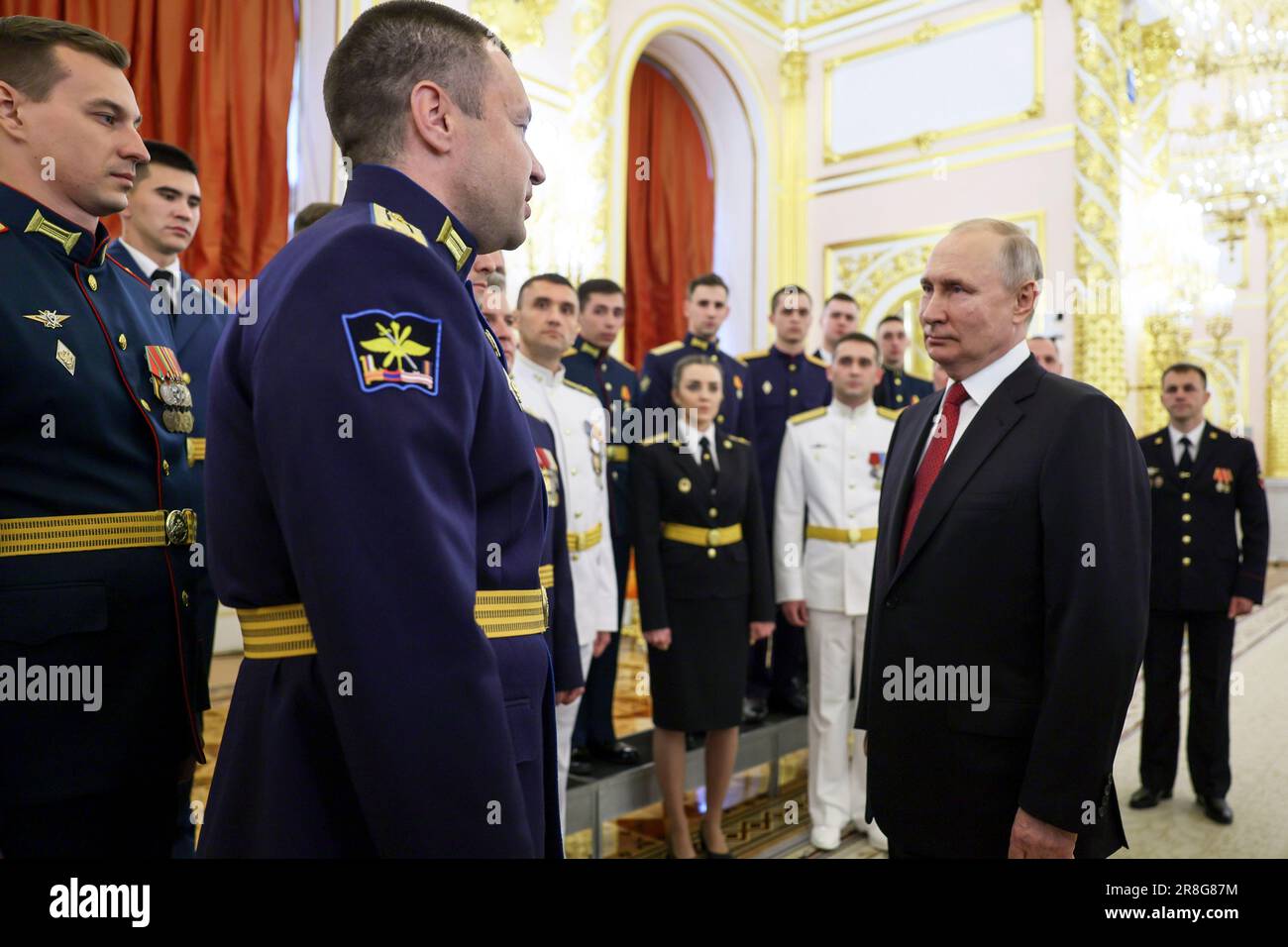 Russian President Vladimir Putin, right, speaks to graduates of ...