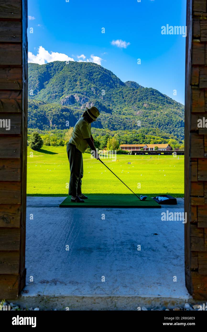 Golfer on Driving Range with Mountain in Switzerland Stock Photo - Alamy