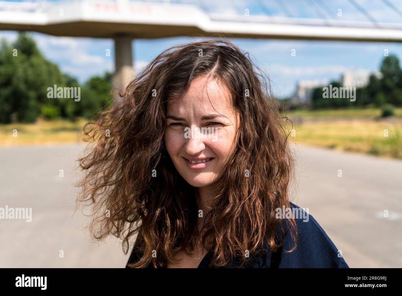 Young woman with open hair in urban setting Stock Photo - Alamy