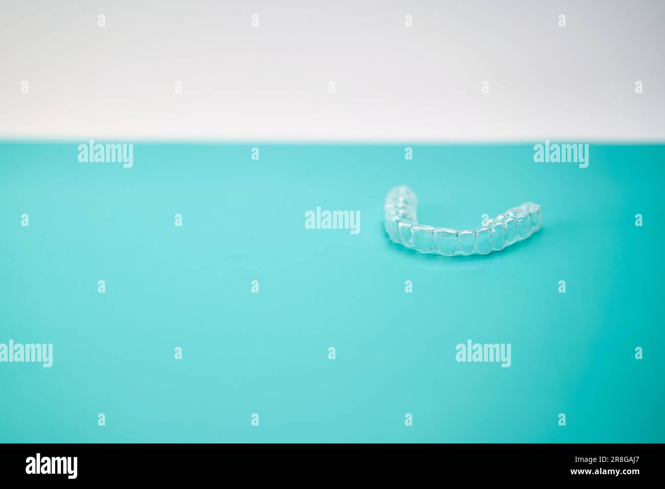 Invisible dental orthodontic appliance on a green table in a dental ...