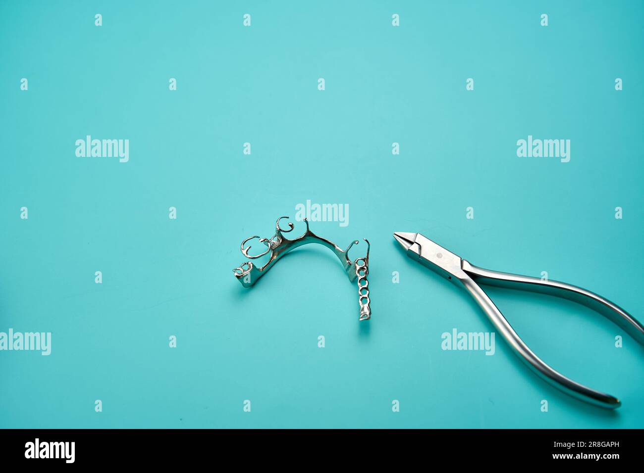 Dental tool and metal denture skeleton on a green table Stock Photo - Alamy