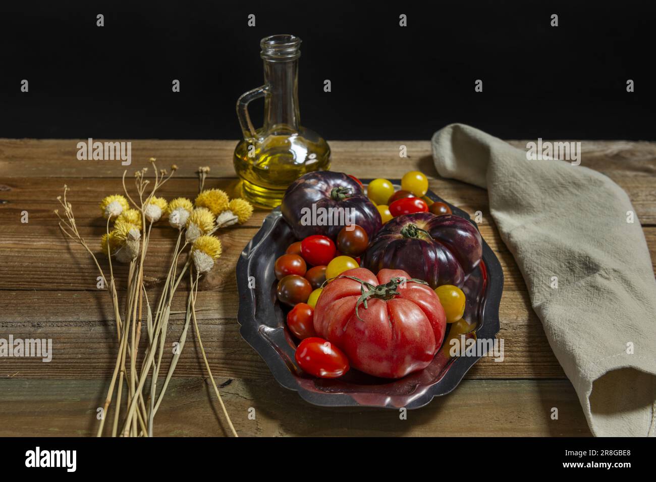 Still life with tomatoes of various kinds with a little olive oil on a ...