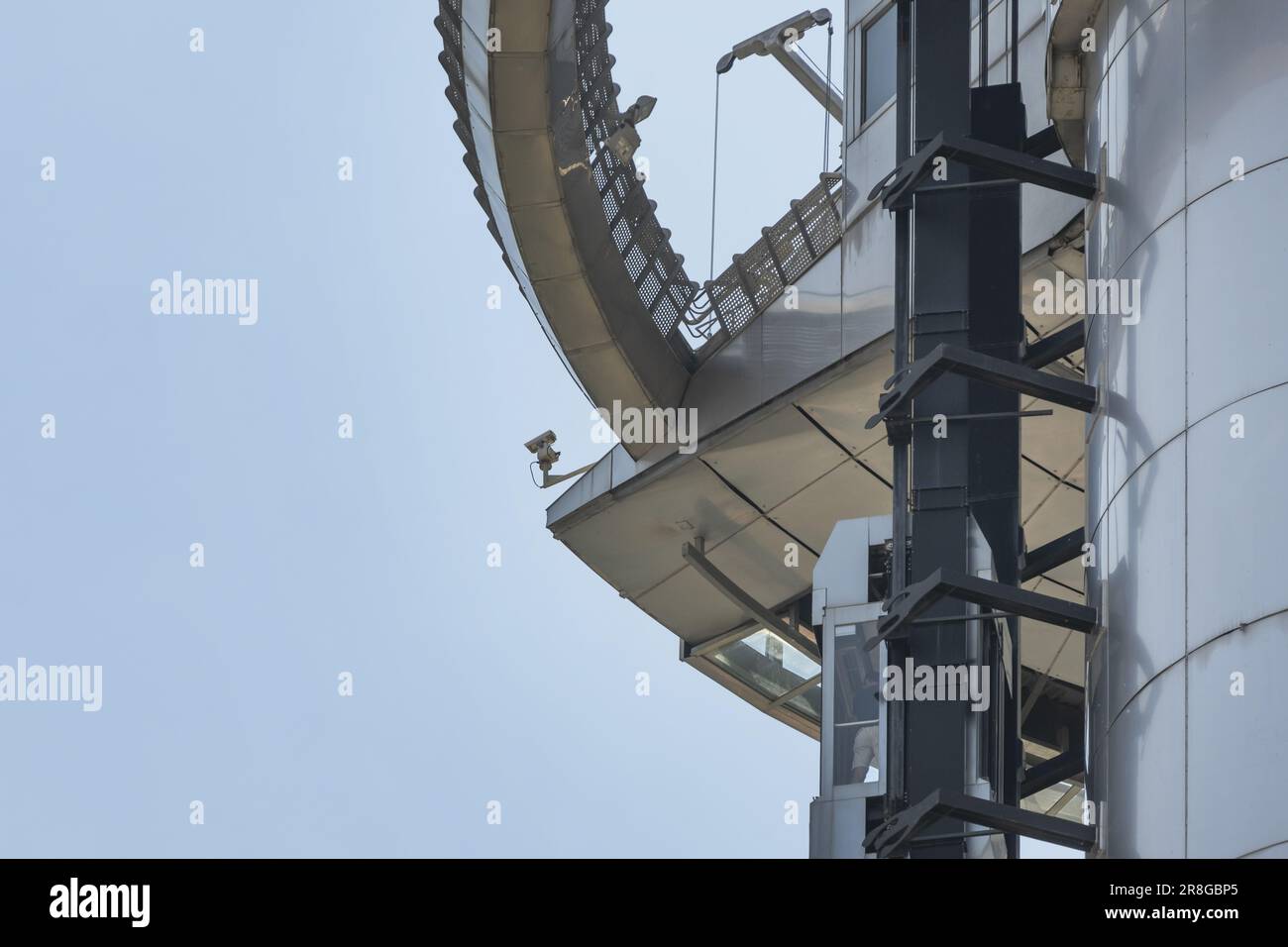 Surveillance cameras placed on a post attached to a metal structure of ...