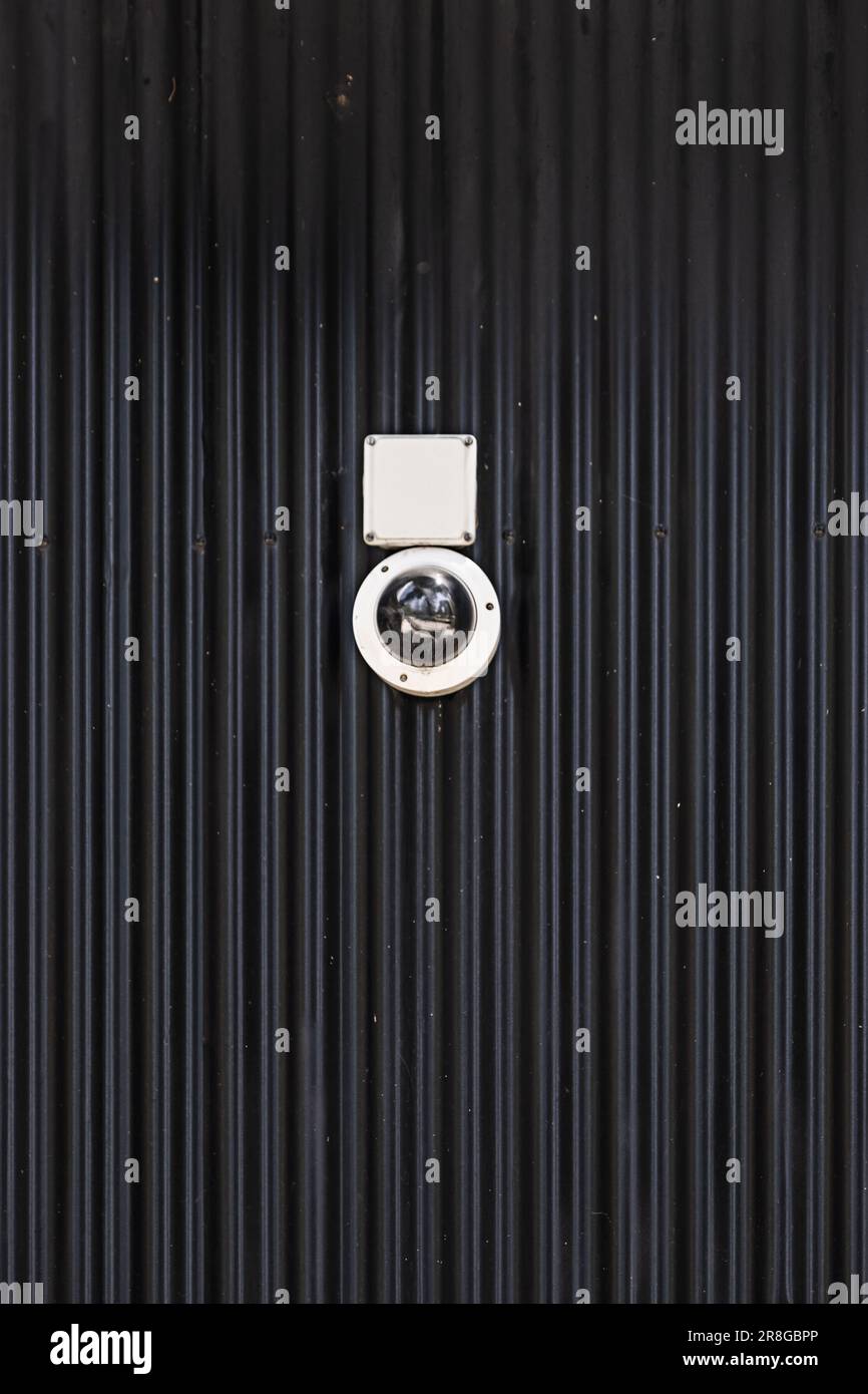 Surveillance cameras placed on a corrugated black metal wall Stock ...