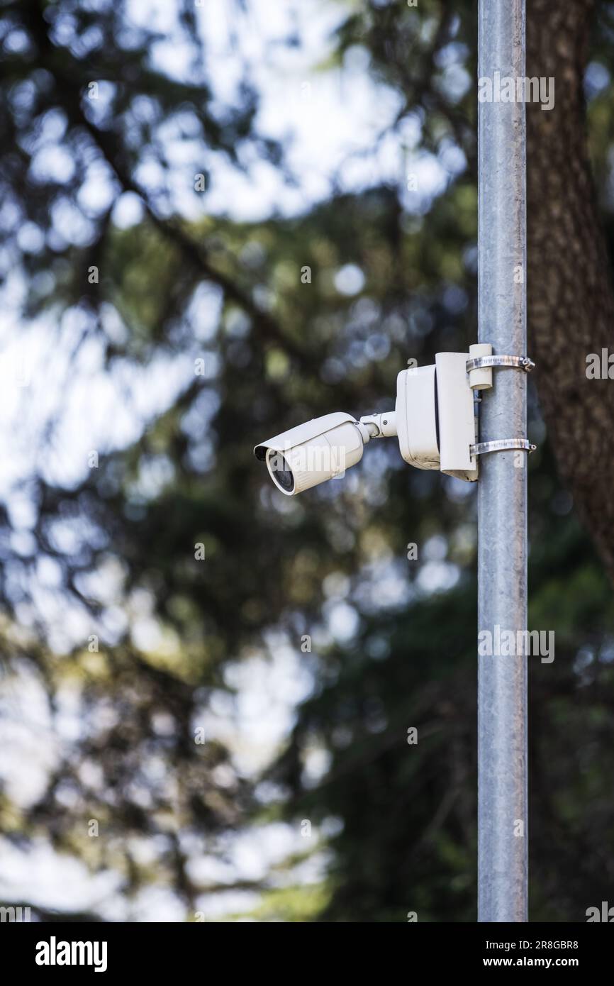 A surveillance camera attached to a metal pole Stock Photo - Alamy