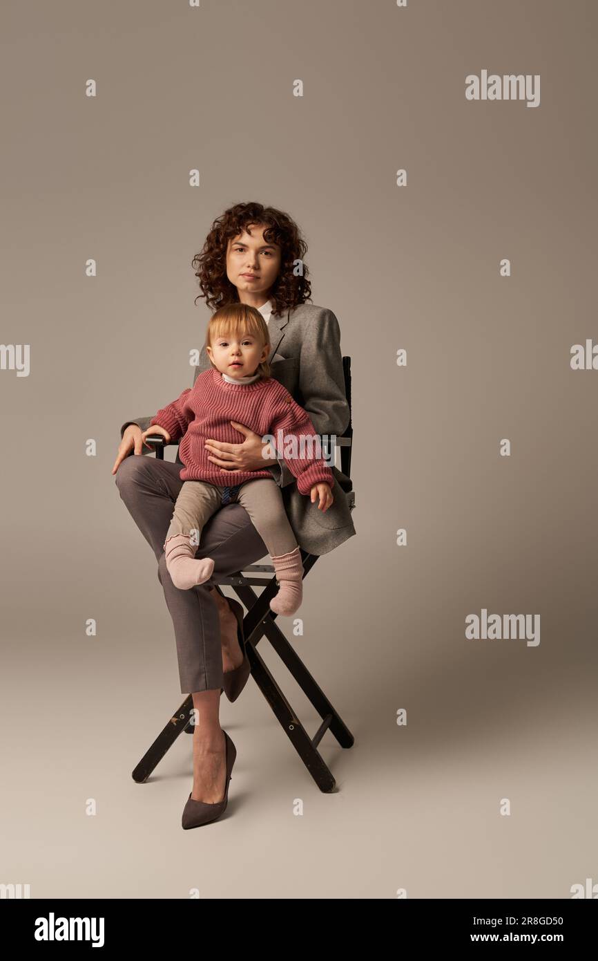 balanced lifestyle, growth and family, curly working mother sitting on ... balanced lifestyle, growth and family, curly working mother sitting on ...