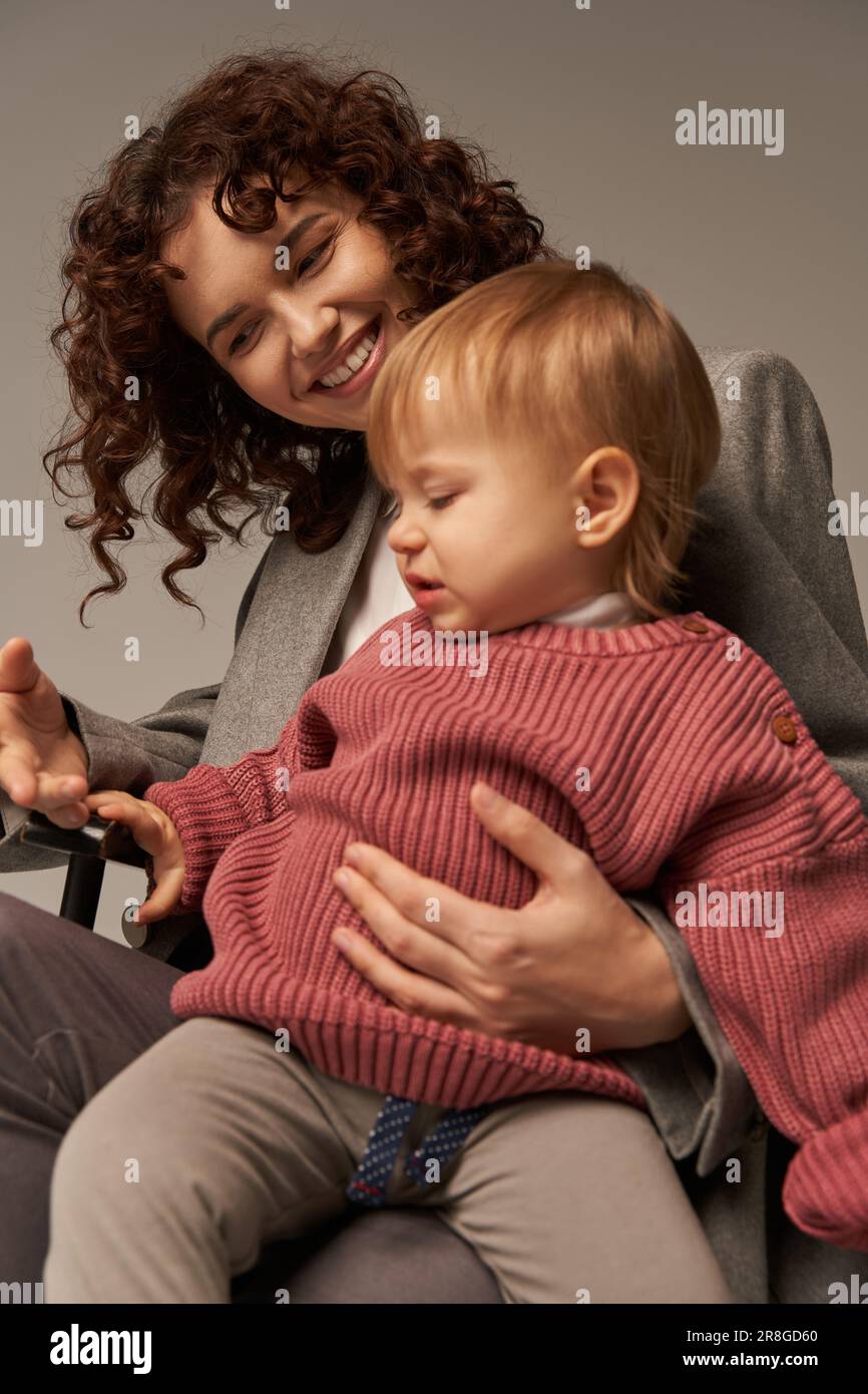 balanced lifestyle, growth and family, happy working mother sitting on ...