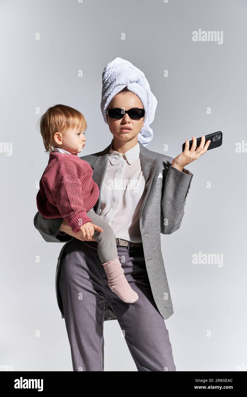 career and family, multitasking, woman in sunglasses holding in arms ...