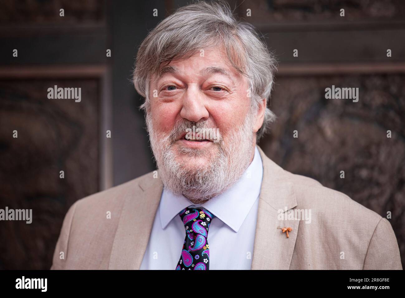 Stephen Fry poses for photographers upon arrival at the National ...