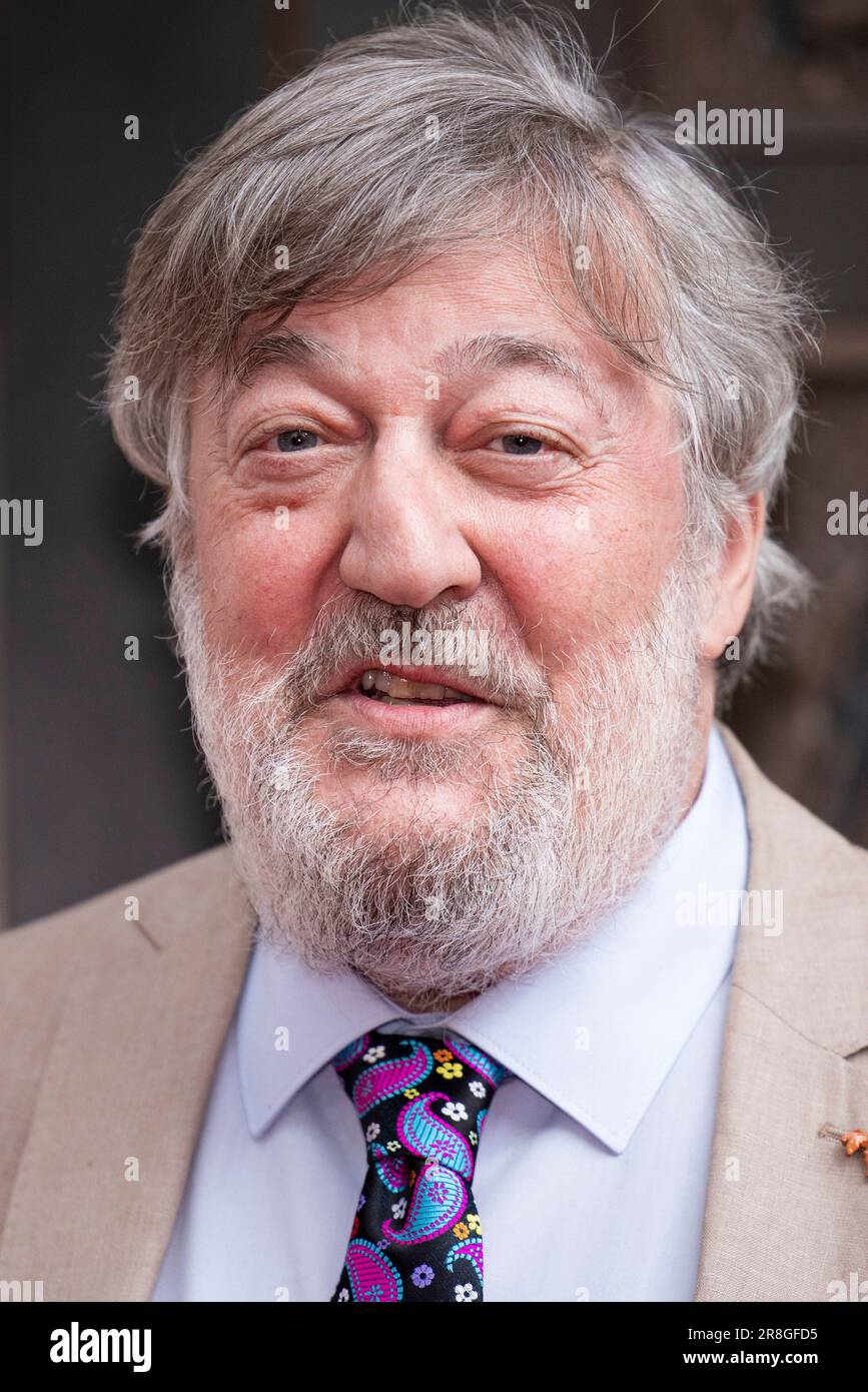 Stephen Fry poses for photographers upon arrival at the National ...