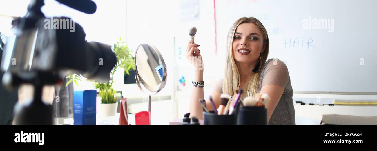 Beautiful woman blogger shows how to apply makeup and use cosmetics ...