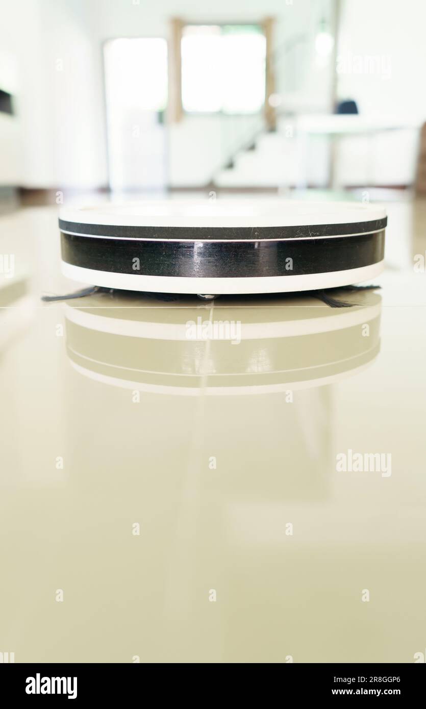 home vacuum cleaning robot cleaning the room Stock Photo - Alamy