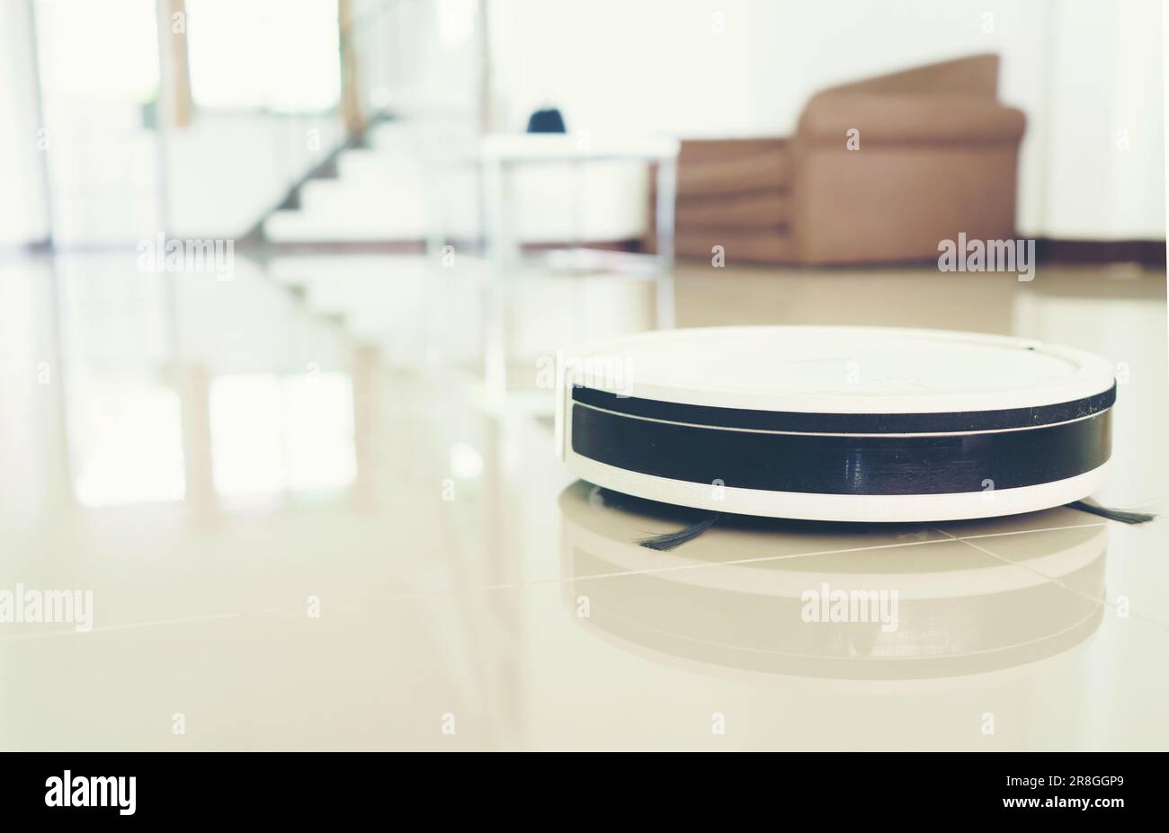 home vacuum cleaning robot cleaning the room Stock Photo - Alamy