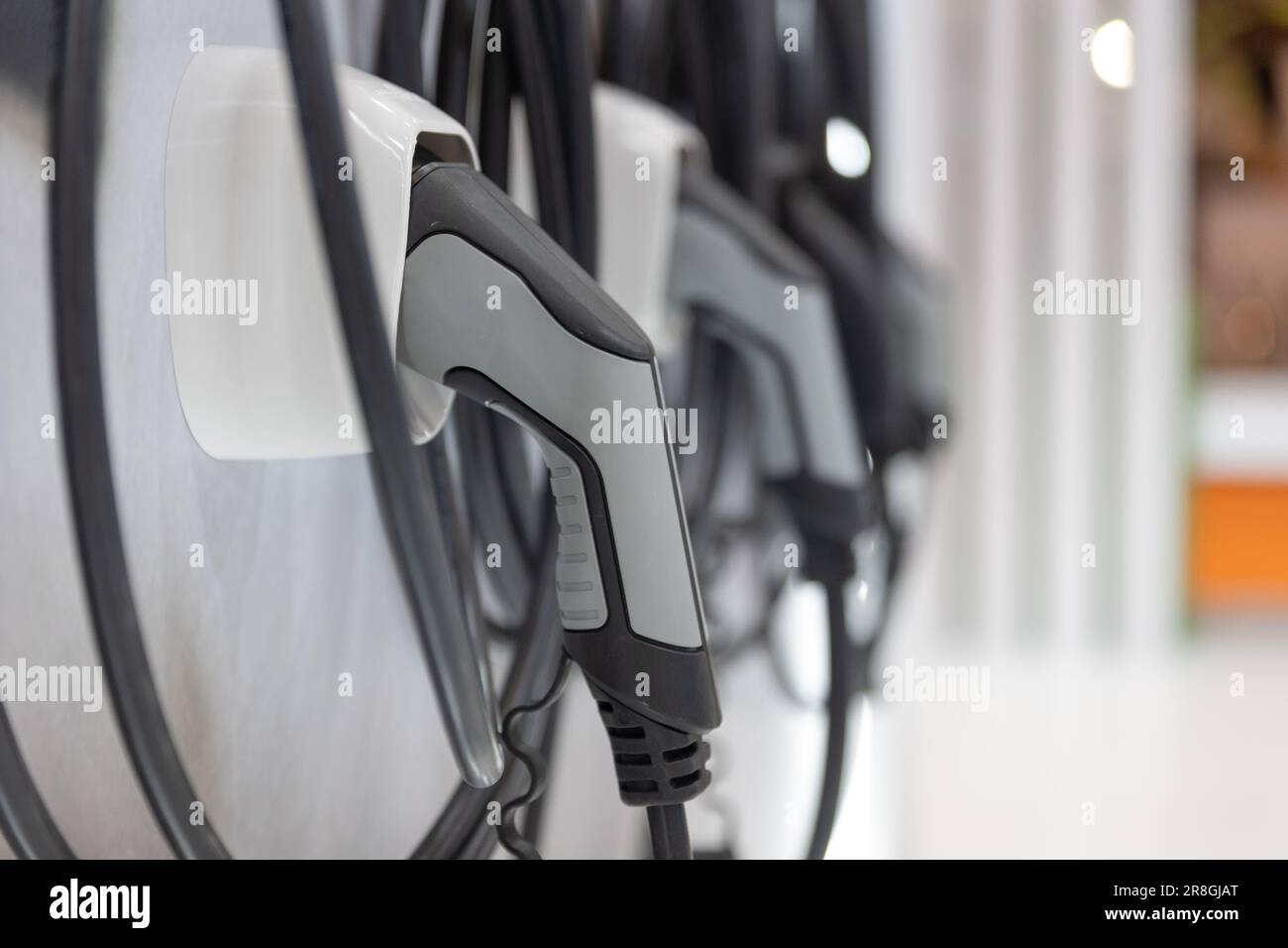 Charging handles at the EV charging station. Mid shot Stock Photo - Alamy
