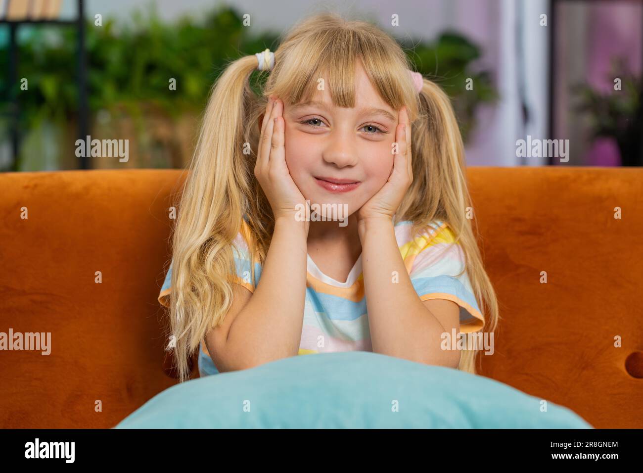 Close-up portrait of happy smiling Caucasian preteen school girl 7 years old. Young blonde ...