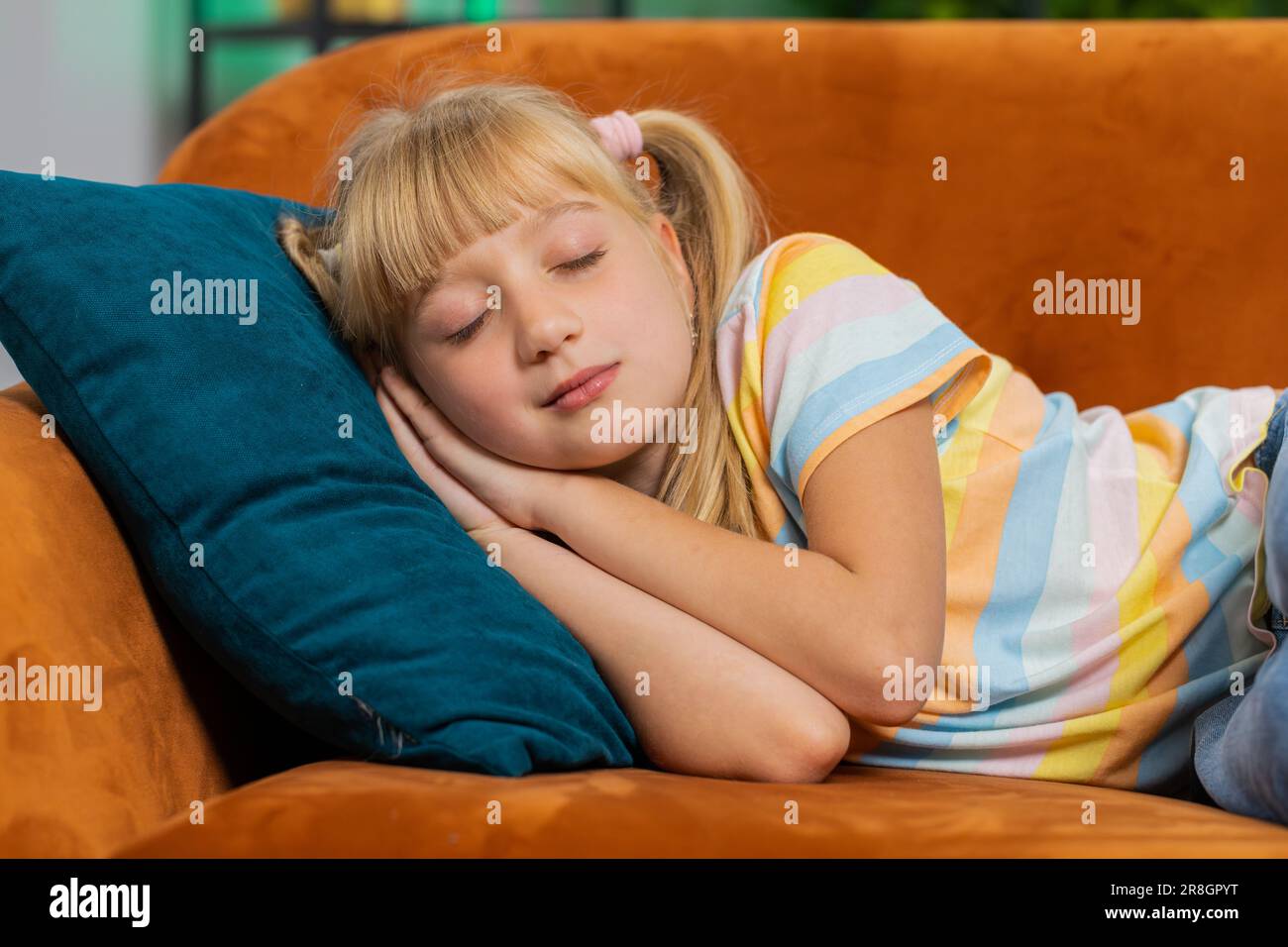 Tired preteen school girl lying down in bed taking a rest at home on ...
