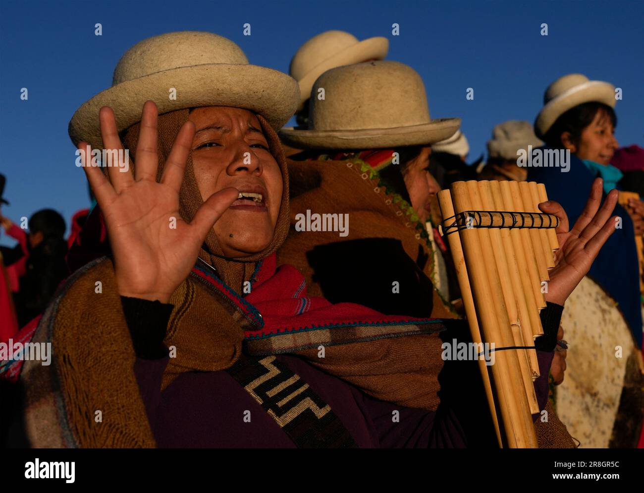 An Aymara Indigenous woman receives the first rays of sunlight in a New ...