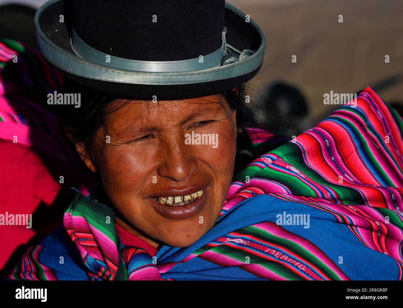 An Aymara Indigenous woman smiles as she receives the first rays of ...