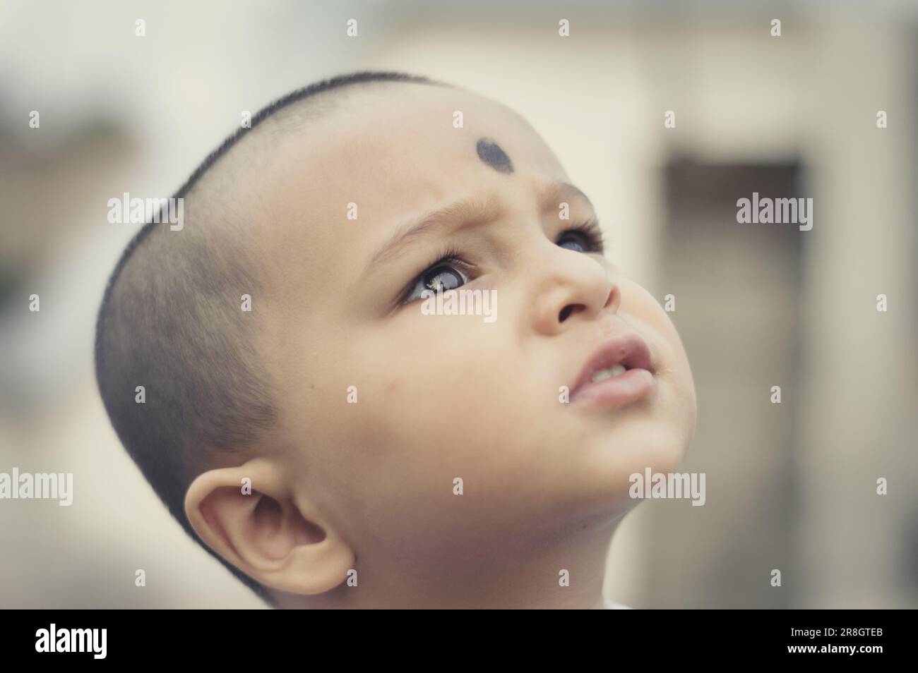 Close up Adorable baby boy in the evening sunlight looking at the ...