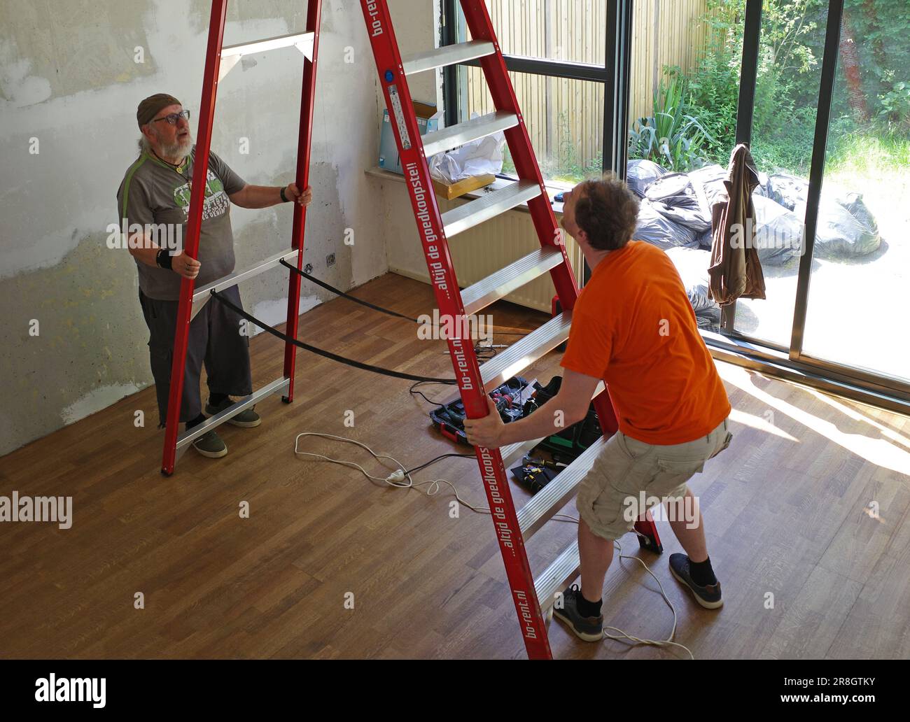 Amersfoort, Netherlands - June 11 2023 Two men move a rented high ...
