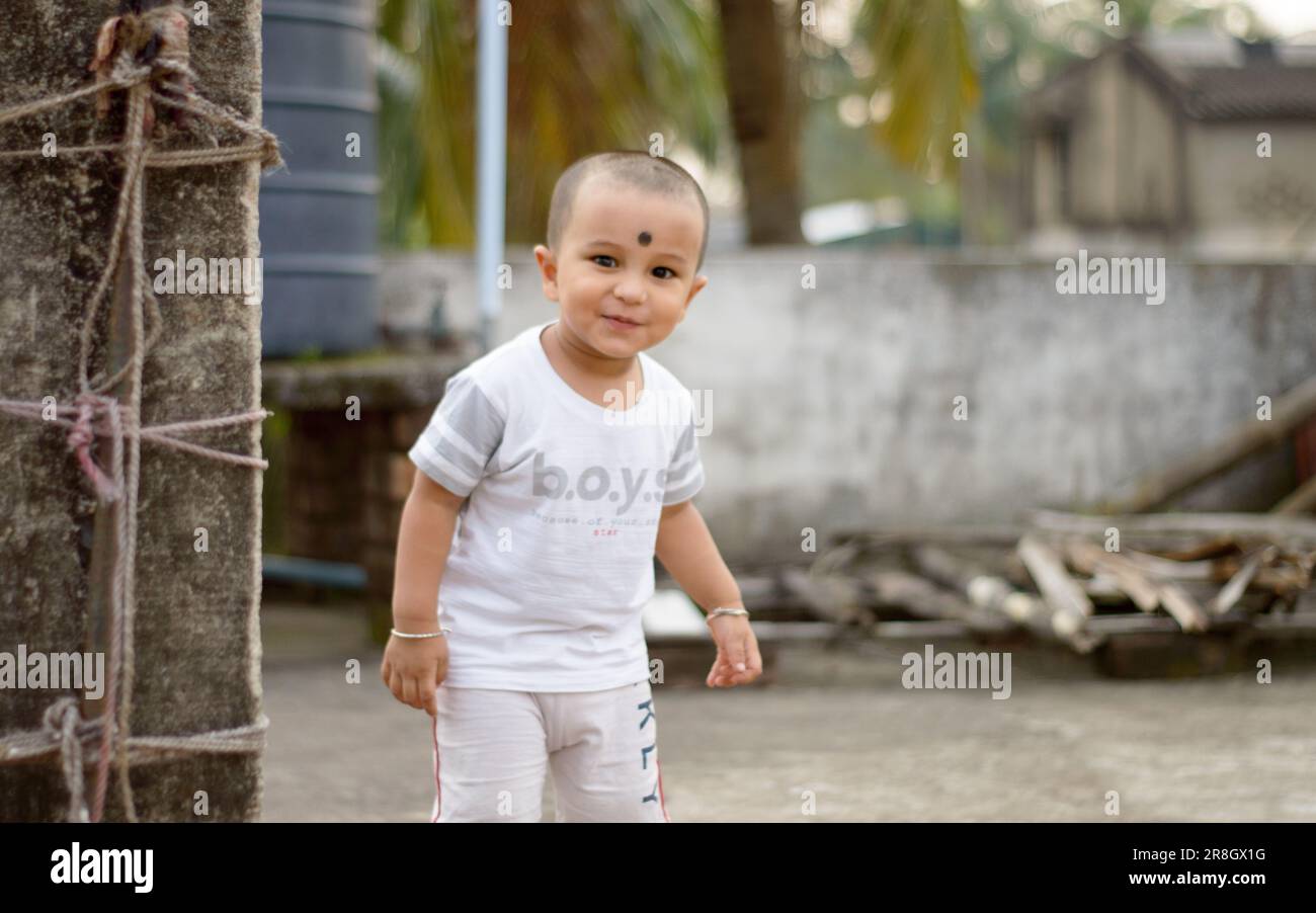 Cute smart naughty baby making a funny and looking at camera. Happy ...