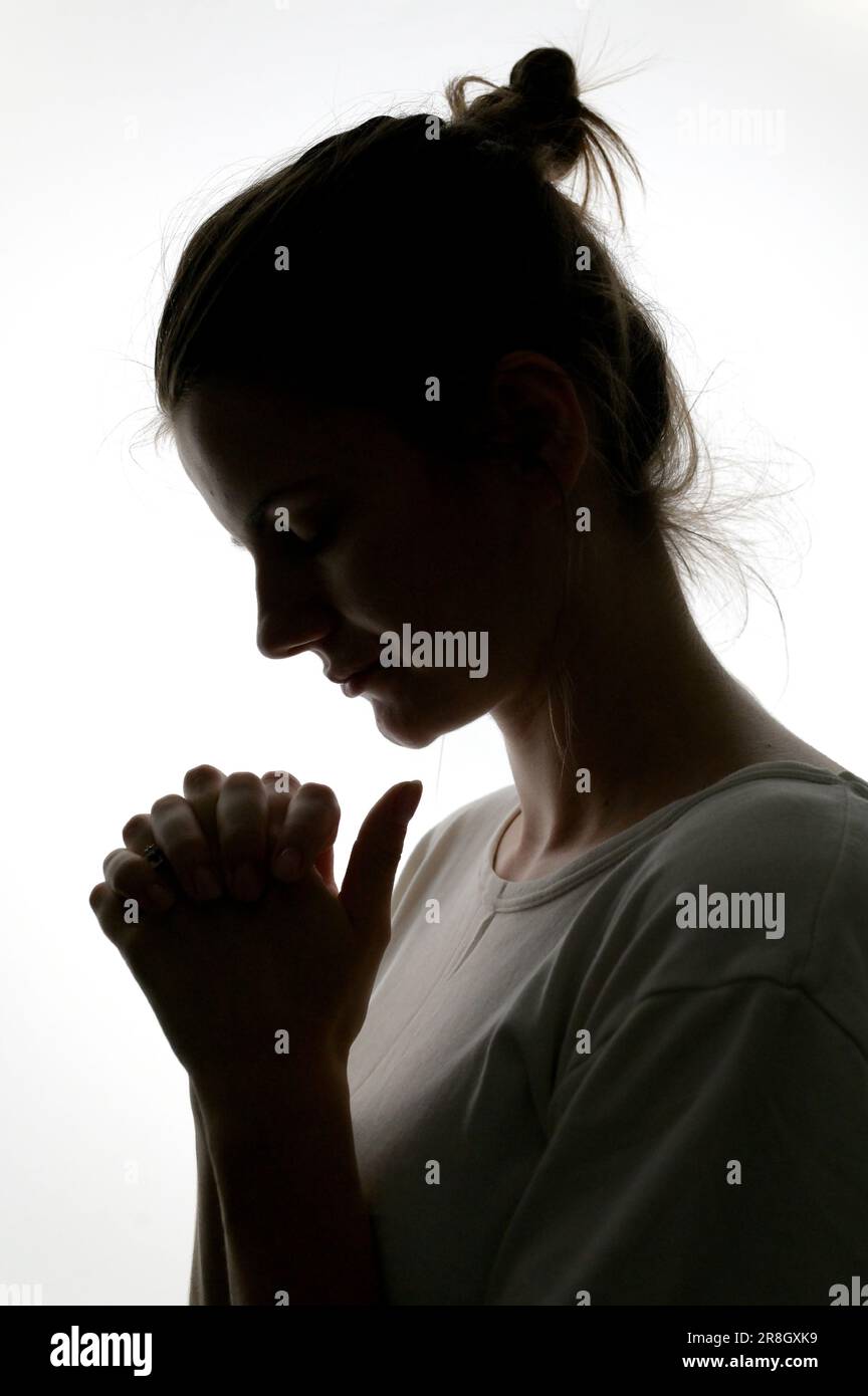 Closeup Profile Of A Woman Praying In Silhouette Isolated in Studio ...
