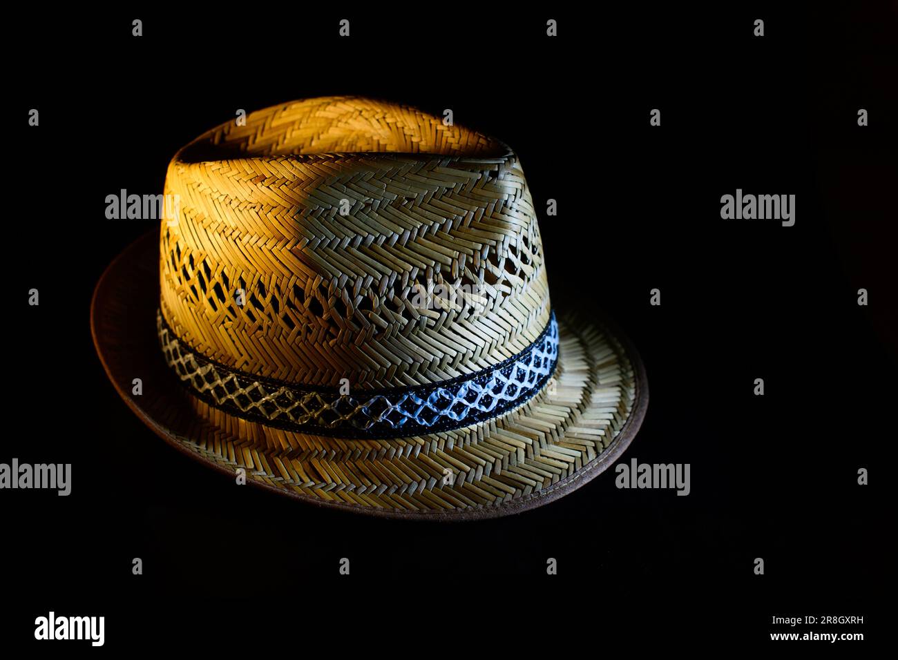 Handmade real straw summer hat on black background Stock Photo - Alamy
