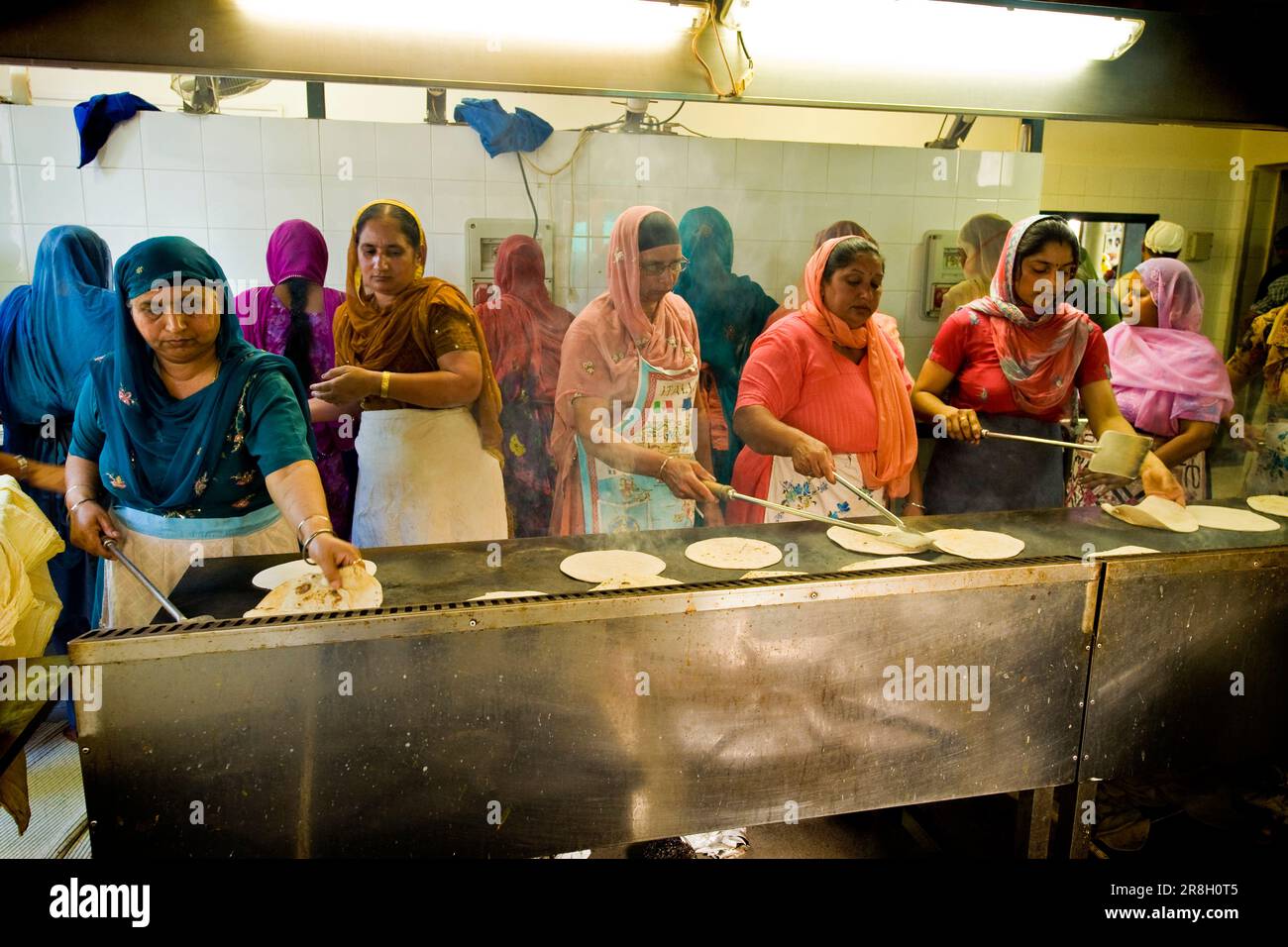 Women who cook chapati. Sikh community. Sikhdharma Gurdwara Singh Sabha ...