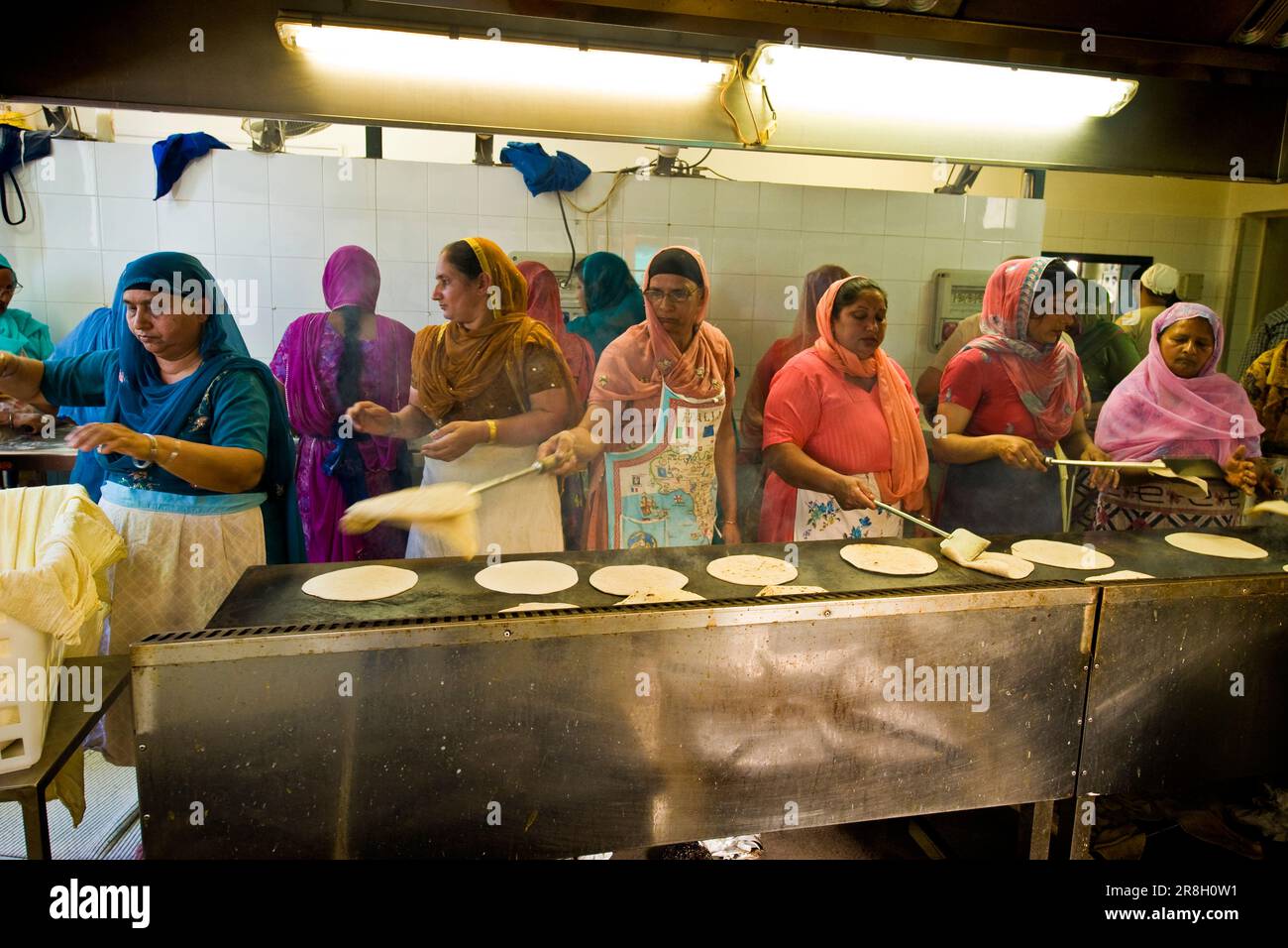 Women who cook chapati. Sikh community. Sikhdharma Gurdwara Singh Sabha ...