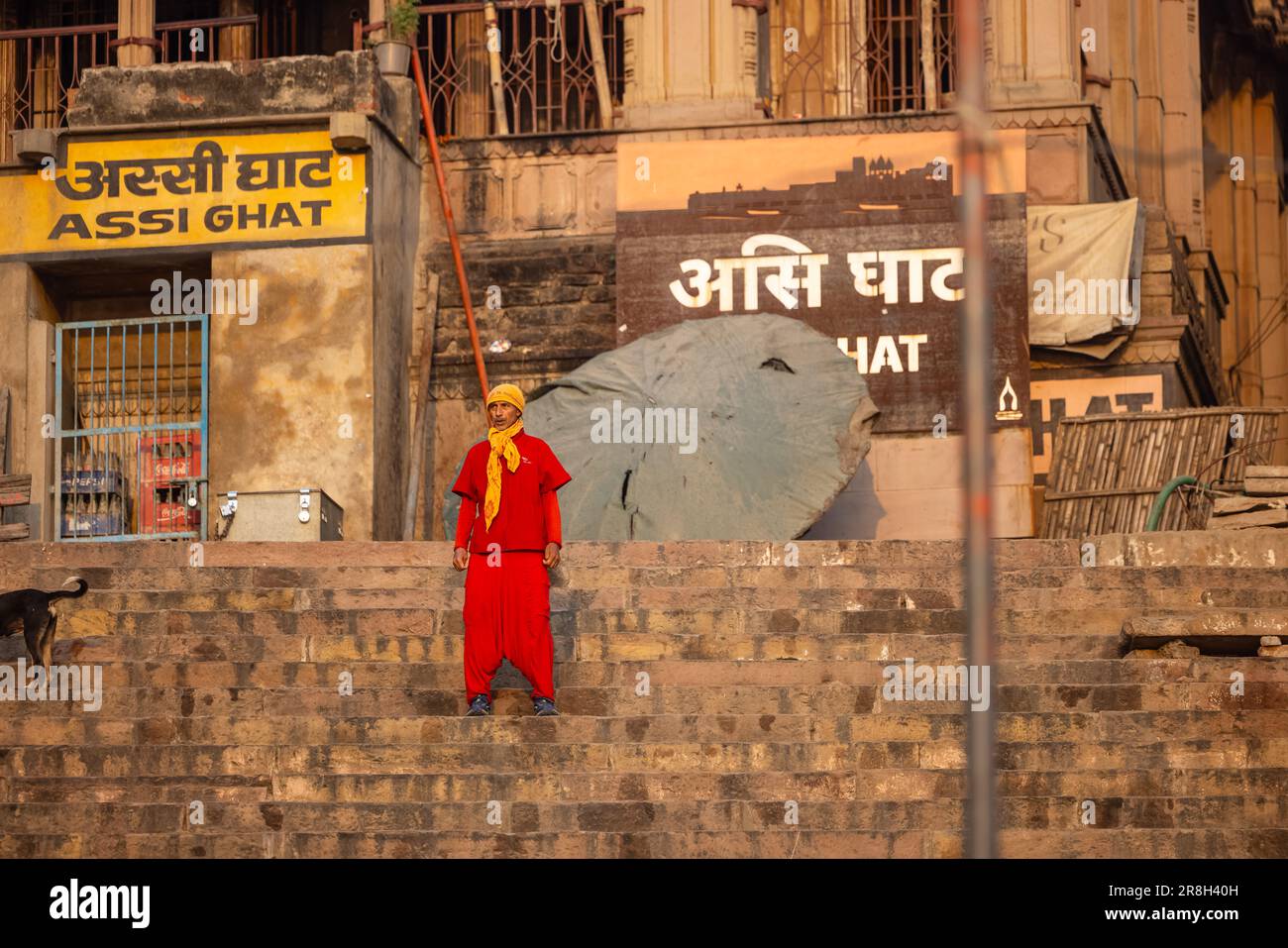 Portrait of an man from nepal standing on stairs at assi ghat in ...