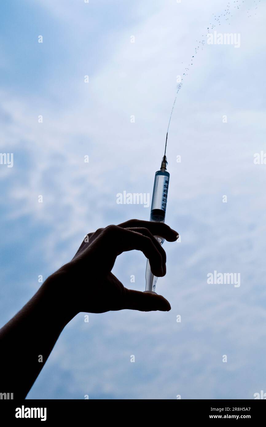 Hand with Syringe Stock Photo - Alamy