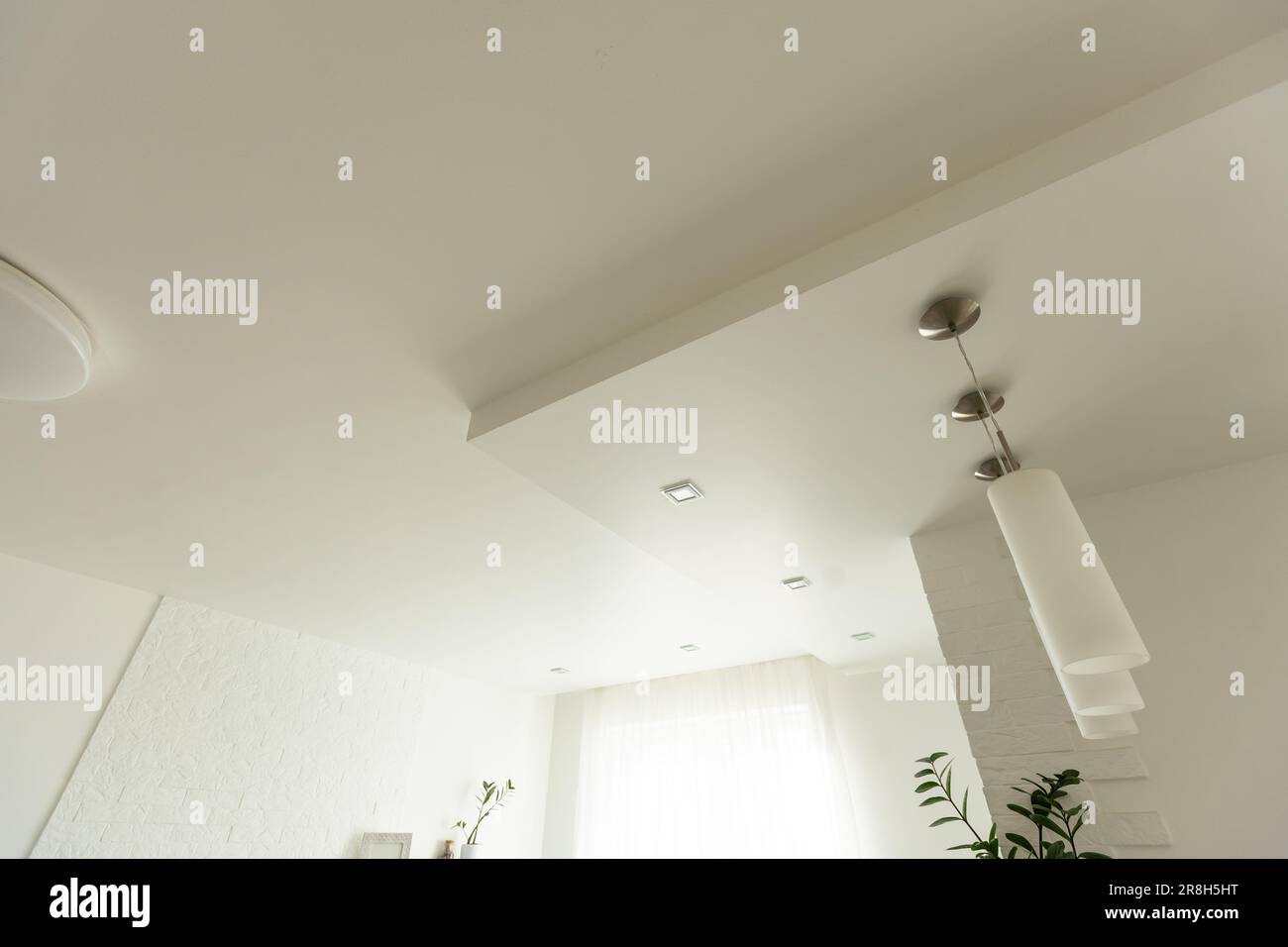 Clean gypsum board ceiling in construction site. Under construction a ...