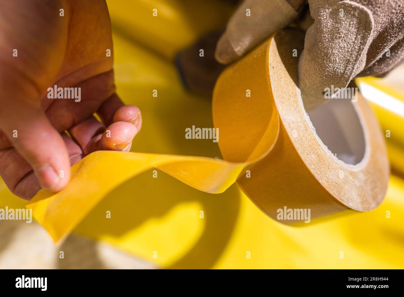 Closeup of Yellow Industrial Masking Tape in Hands of Professional ...