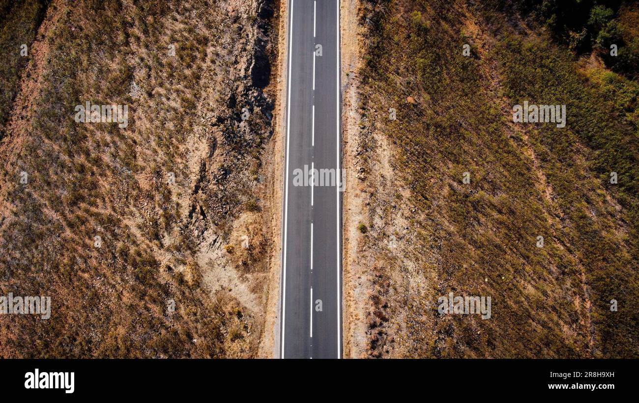 An aerial view of a small street in a rural area with a road cutting ...