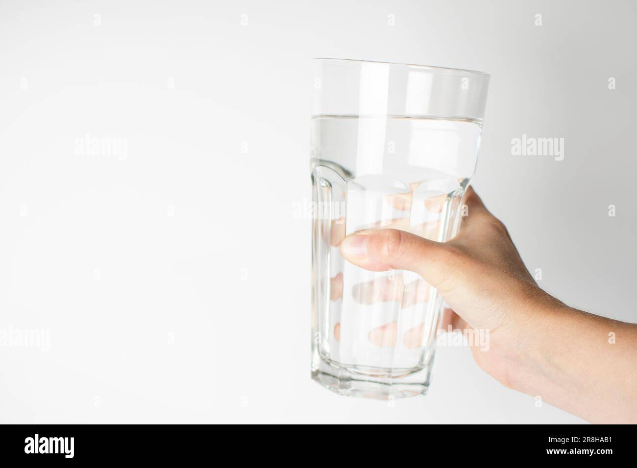 Hand holding a clear glass of water on the white background Stock Photo ...